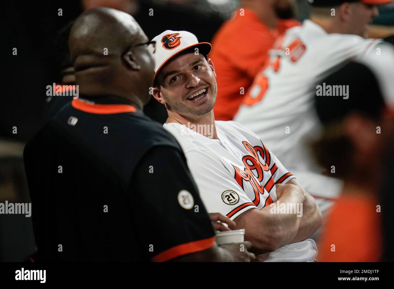 Baltimore Orioles' Trey Mancini, center, talks with assistant athletic ...