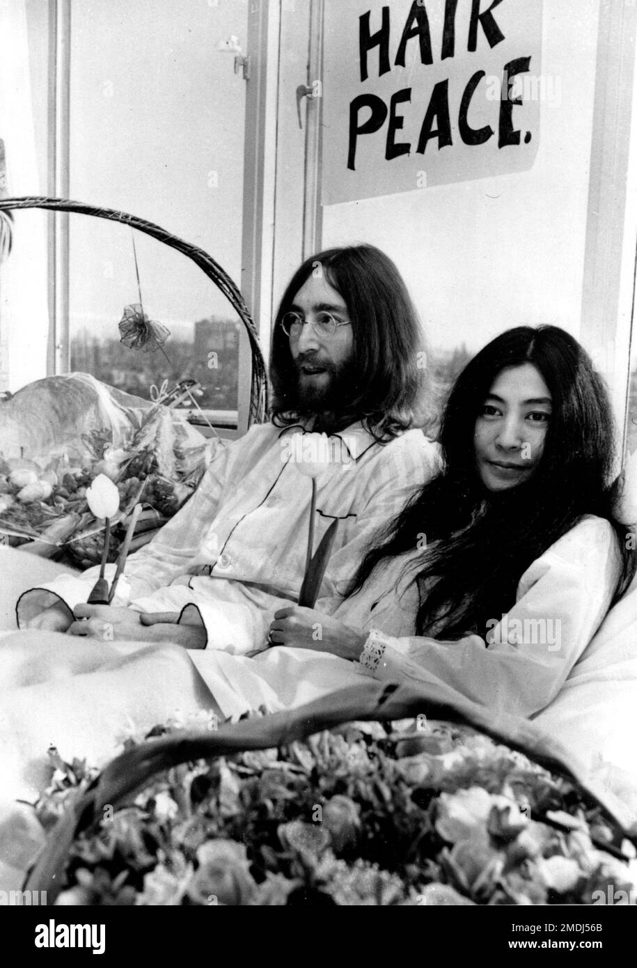 FILE - In this March 25, 1969 file photo, musician John Lennon and his wife Yoko Ono hold a bed ...