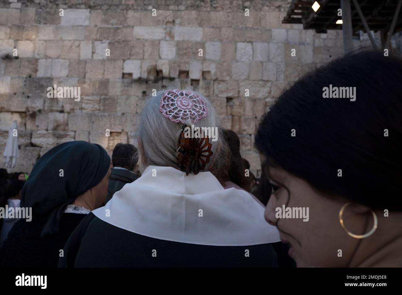 A member of Women of the Wall, center, wears a head covering during the ...