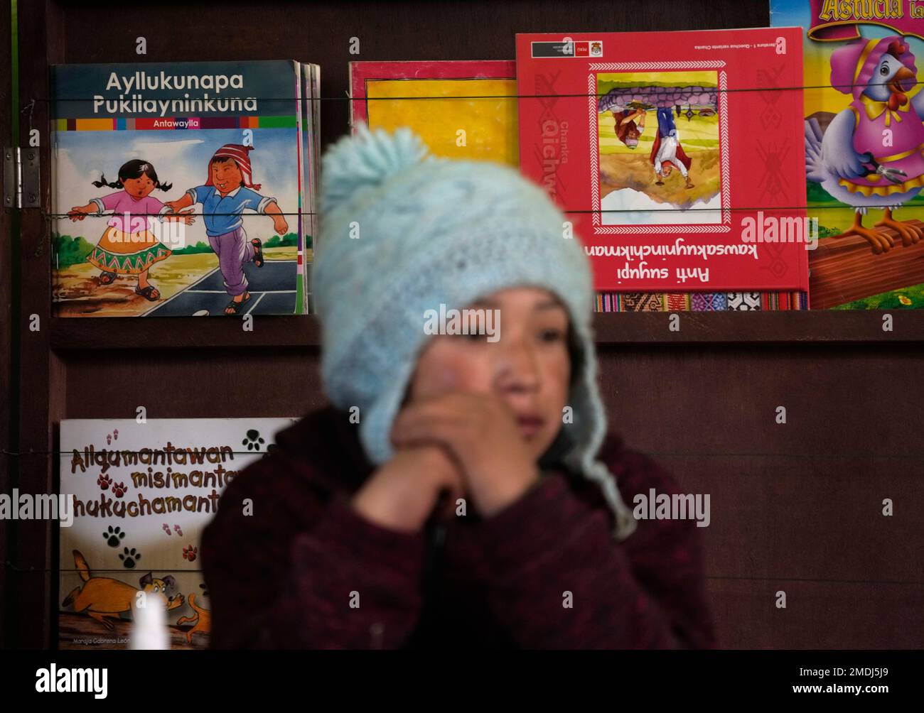 Books written in the Quechua Indigenous language sit behind a student ...