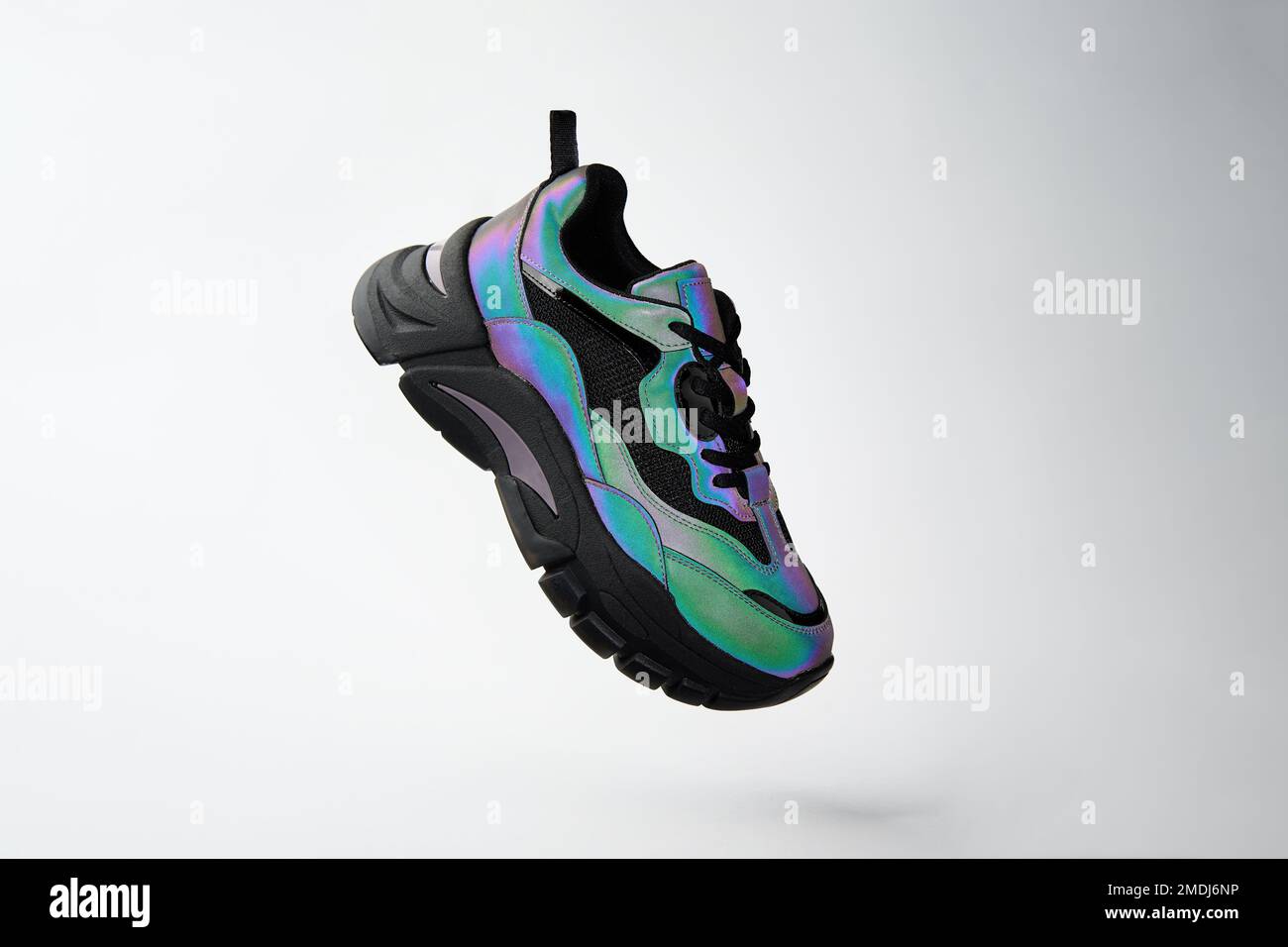 Stylish sneaker with neon gradient on white background. Glowing ...