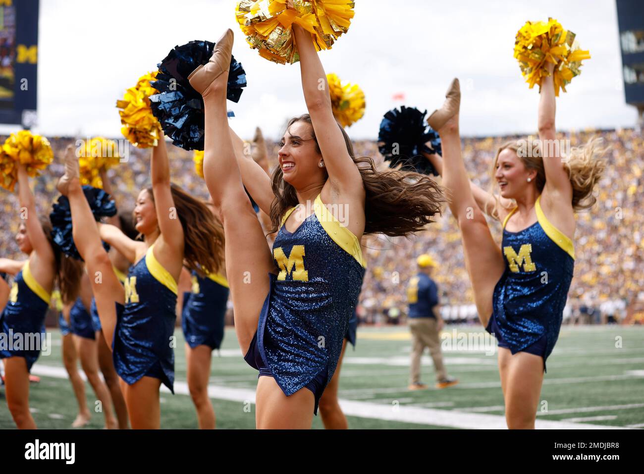 Michigan dance team members perform during an NCAA football game ...