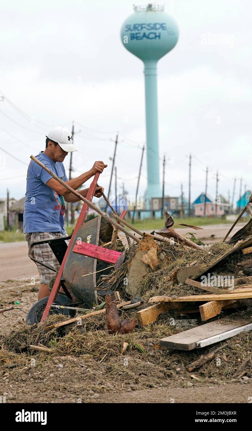 Billy Tran cleans up storm debris from Hurricane Nicholas Tuesday, Sept ...