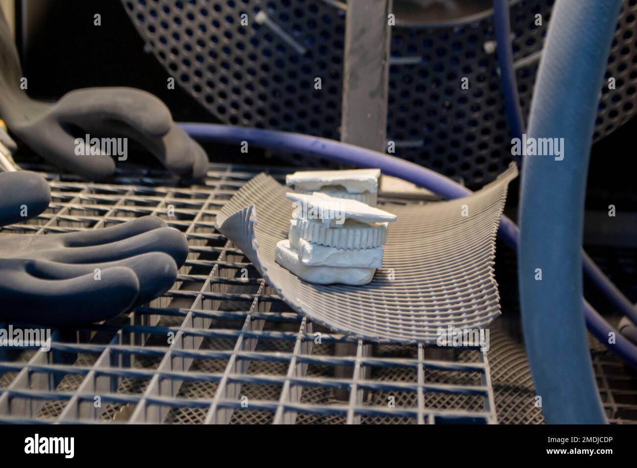 Models printed on a 3D printer from white polyamide powder inside a ...