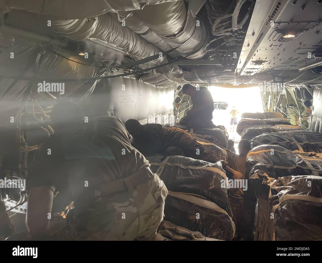 SPC Owens, SPC Loyola, and SPC Johnston attach parachute static lines ...