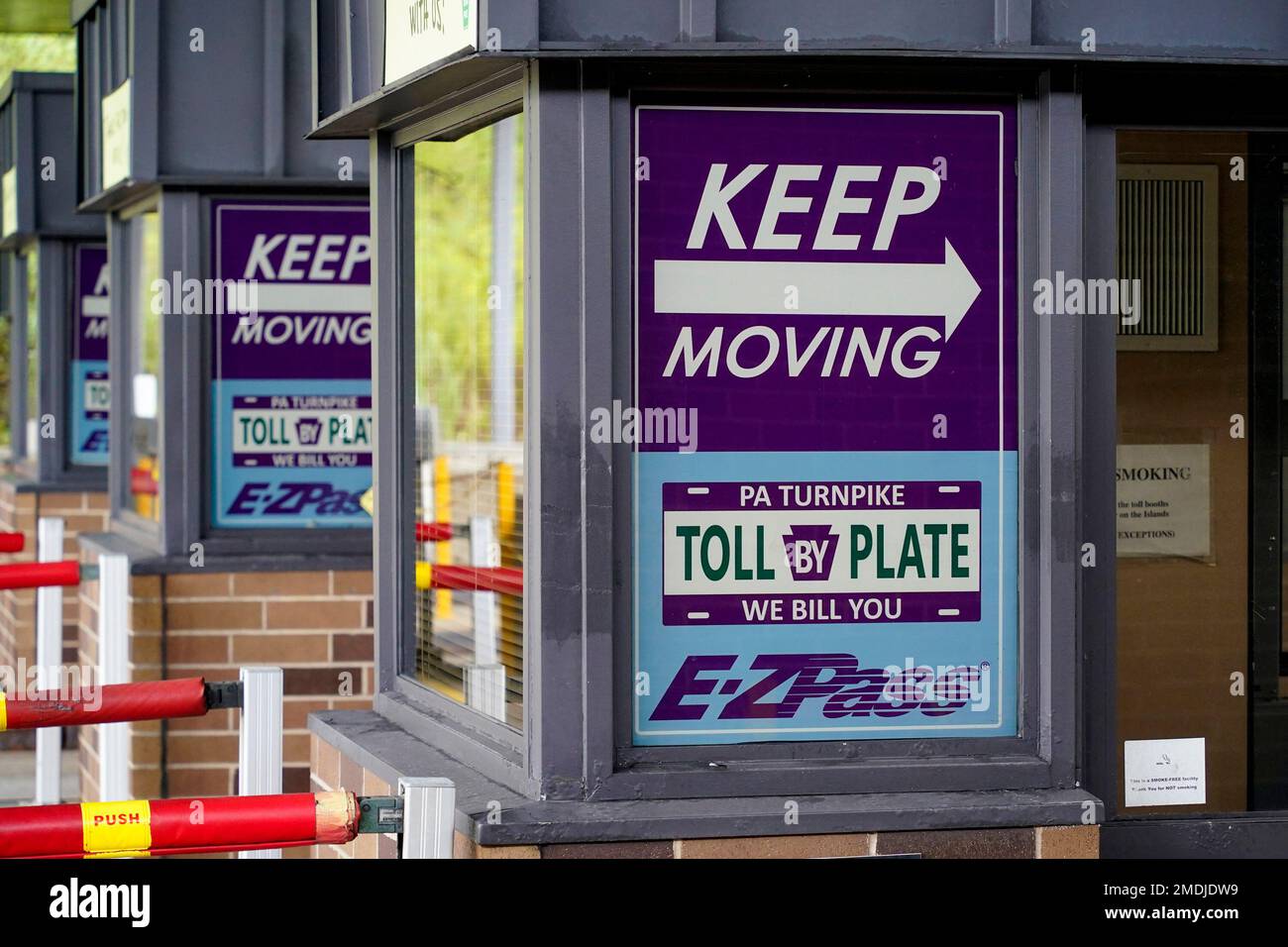 Signs on the electronic toll booths indicate to motorists entering the ...