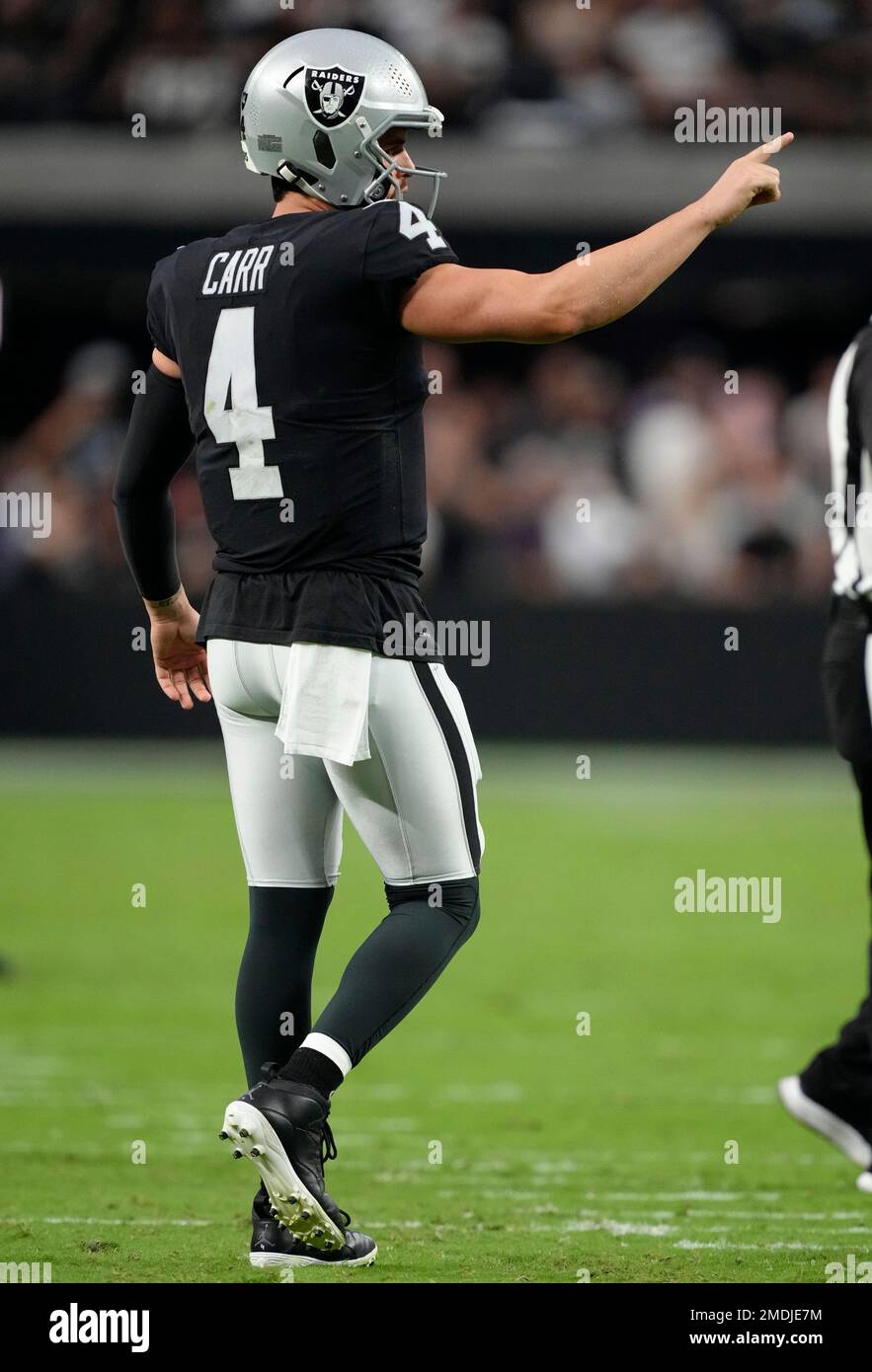 Las Vegas Raiders quarterback Derek Carr (4) walks on the field during ...