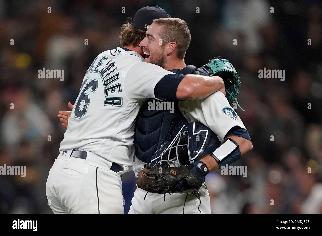 Seattle Mariners catcher Tom Murphy, right, hugs closing pitcher Drew Steckenrider after ...