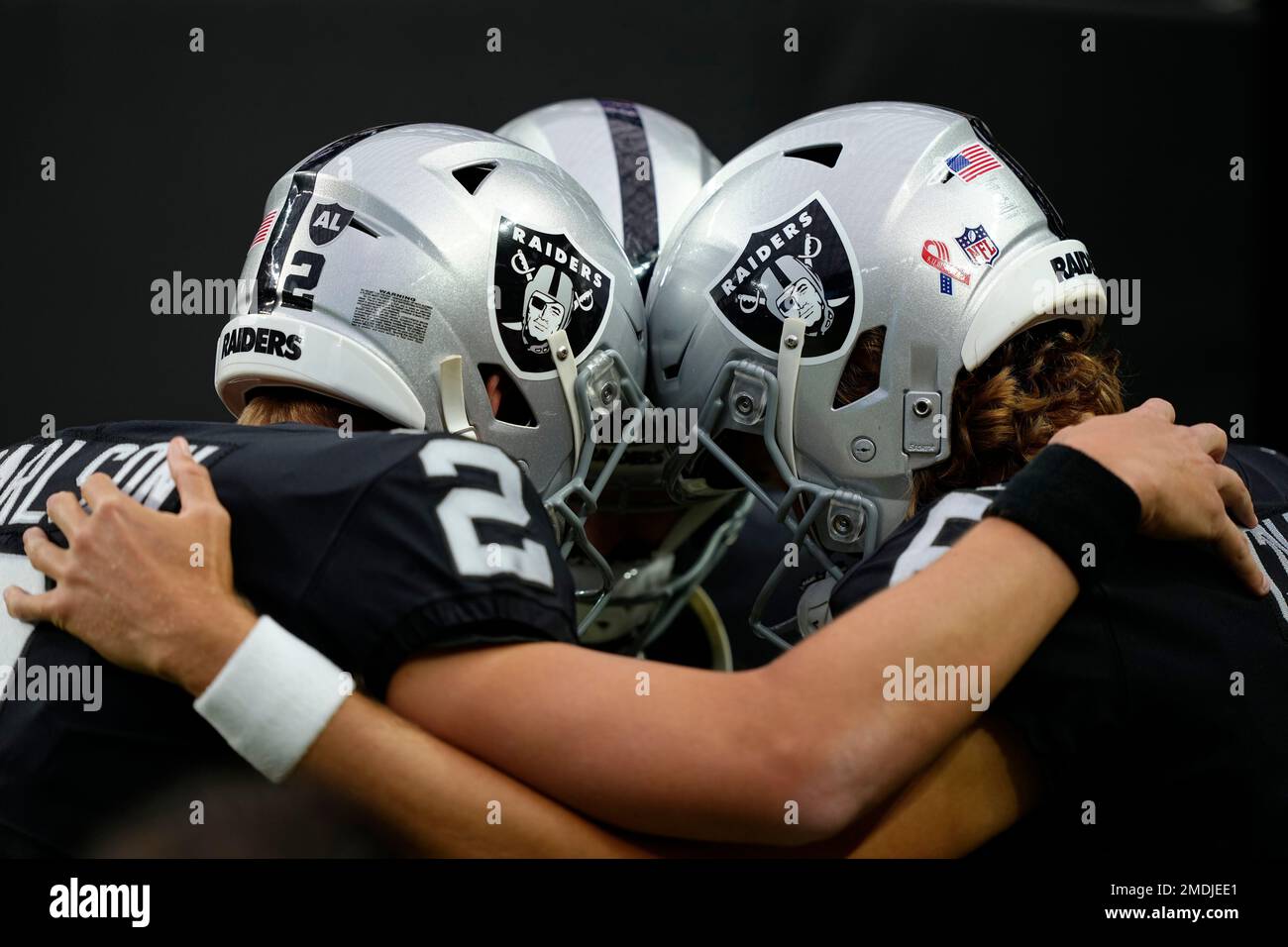 Las Vegas Raiders players huddle on the field prior to an NFL football ...