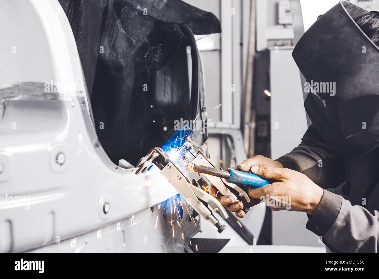 Body shop worker welding car body. Work with carbon dioxide weld Stock ...