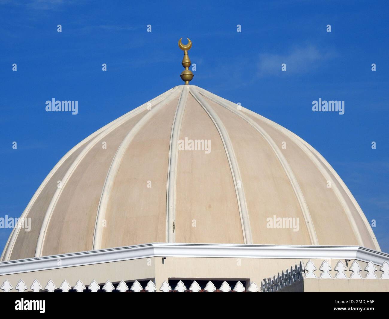 A big dome of a mosque against a lovely blue sky with clouds at the ...