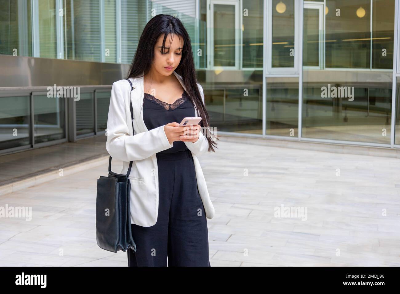 Close up portrait of a young executive business woman in urban outdoors ...