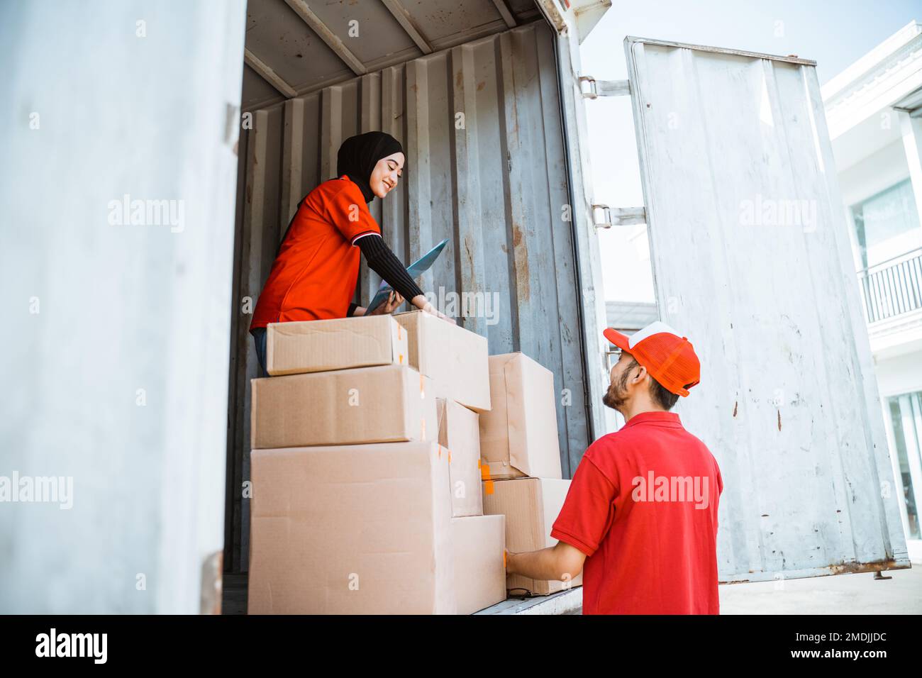 Female courier checking packages hi-res stock photography and images ...