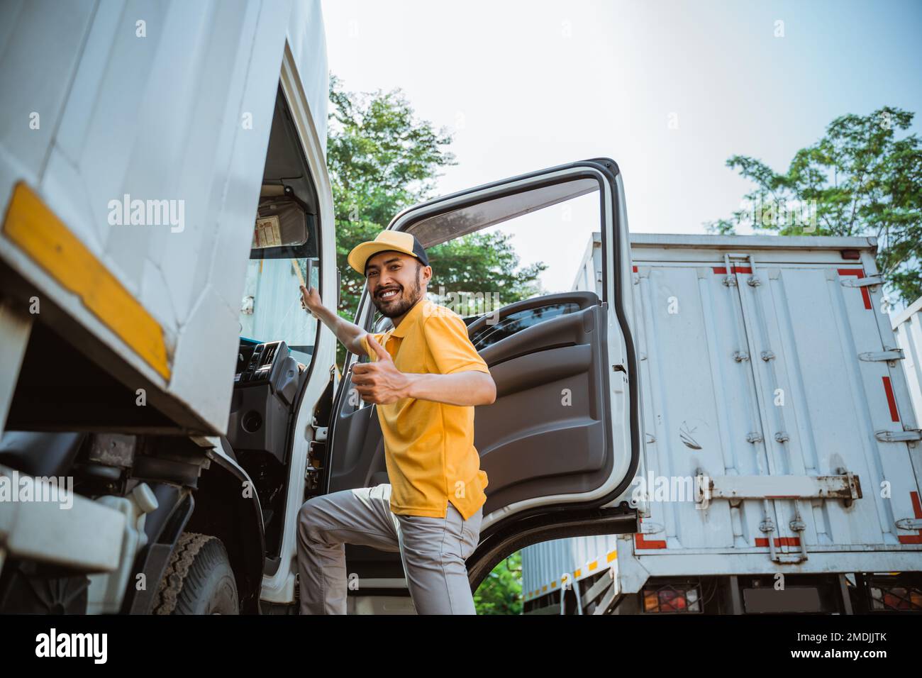 asian male driver with thumbs up entering delivery truck Stock Photo ...