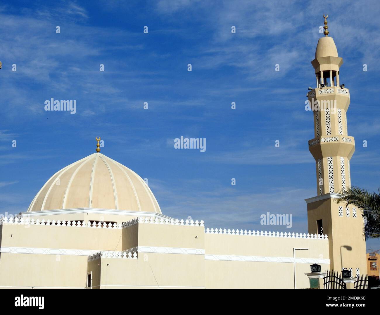 dome and minaret of a mosque against a lovely blue sky with clouds at ...