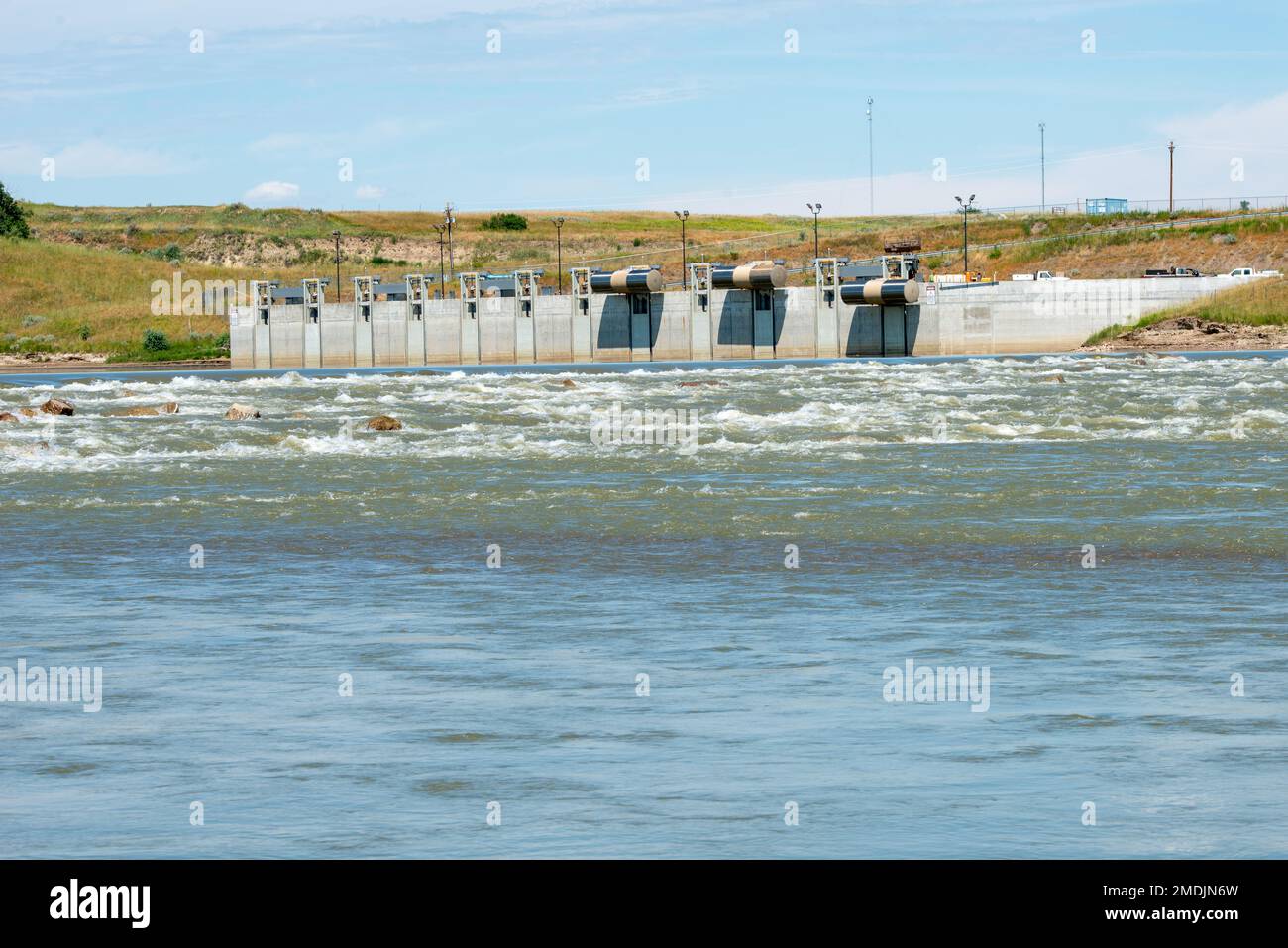Water flows past the Lower Yellowstone intake canal headworks structure ...