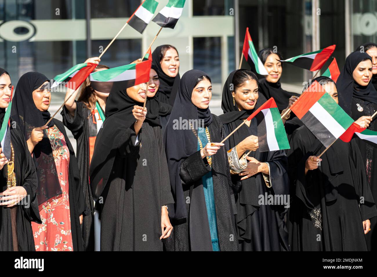Dubai, UAE - November 28, 2022: womens in traditional clothes wave ... Dubai, UAE - November 28, 2022: womens in traditional clothes wave ...