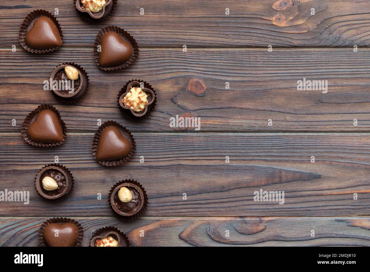 Different kinds of chocolates on colored table close-up. Top View and ...