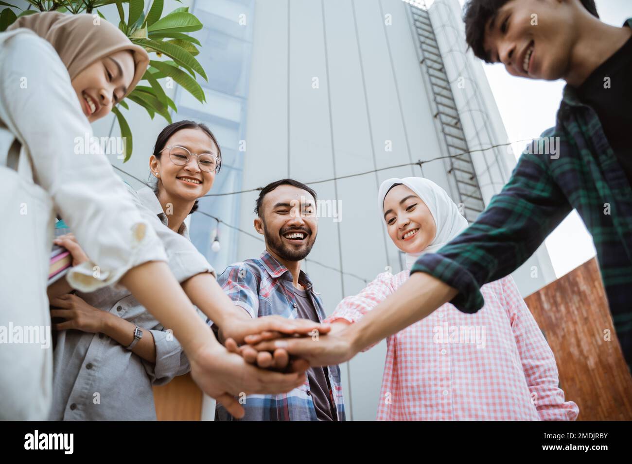 happy young people with united hand gesture while hanging out Stock ...