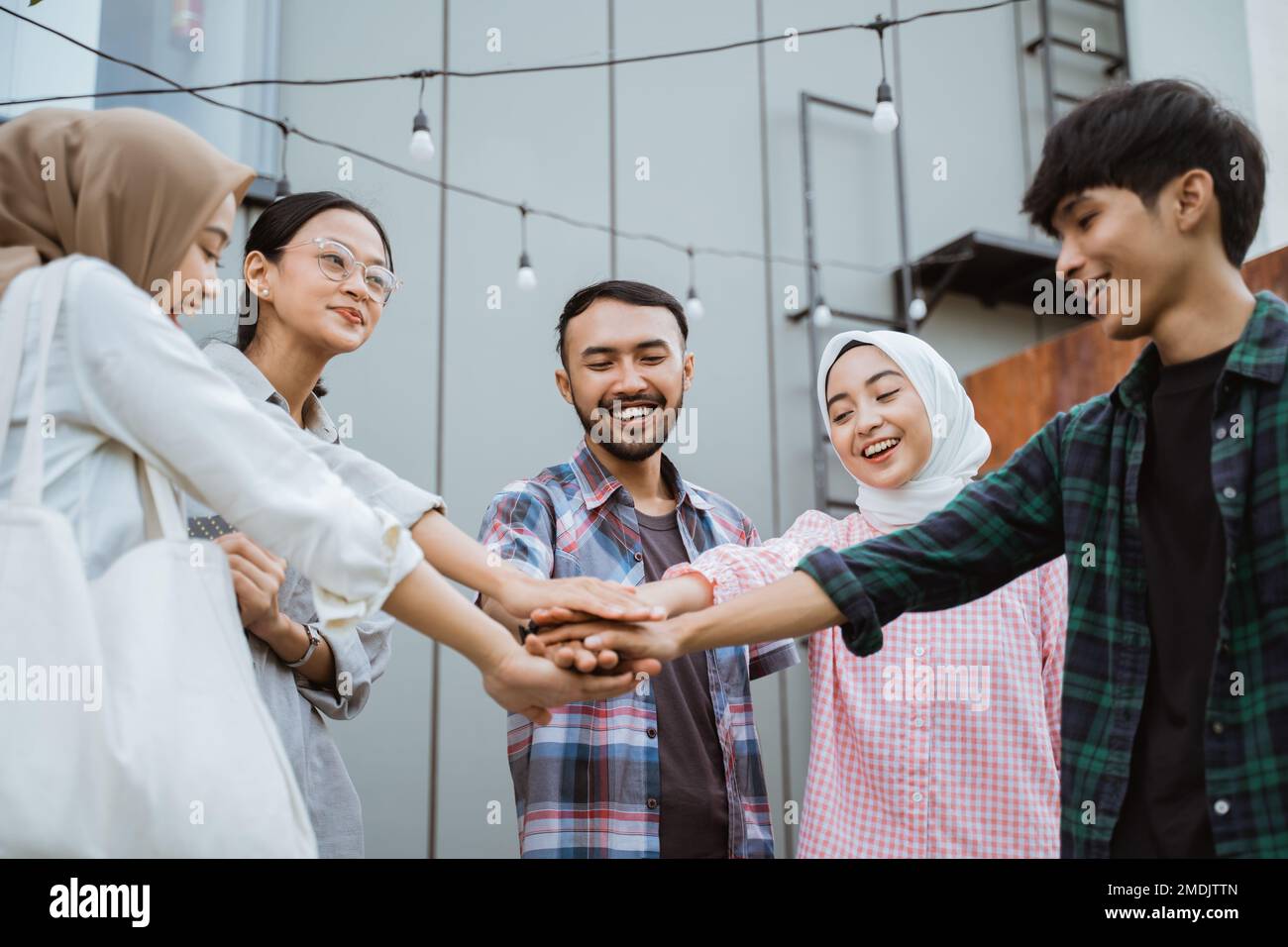 young people with united hand gesture while together hanging out Stock ...