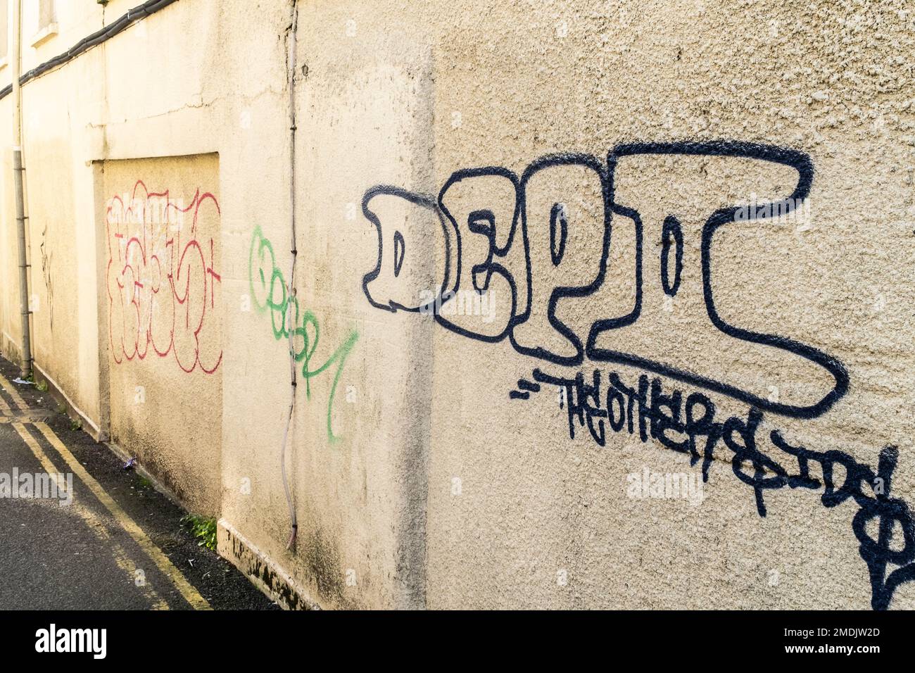 Ugly graffiti tag sprayed over a wall in Newquay town centre in ...