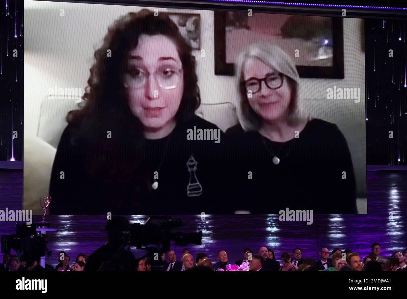 Kate Sprance, left, and Ellen Lewis virtually accepts the Emmy for ...