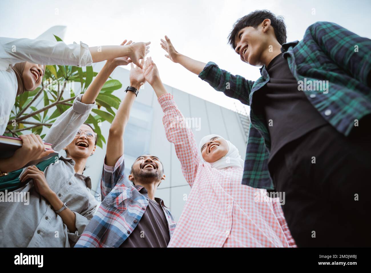 students enthusiastically raised their hands as a sign of unity Stock ...
