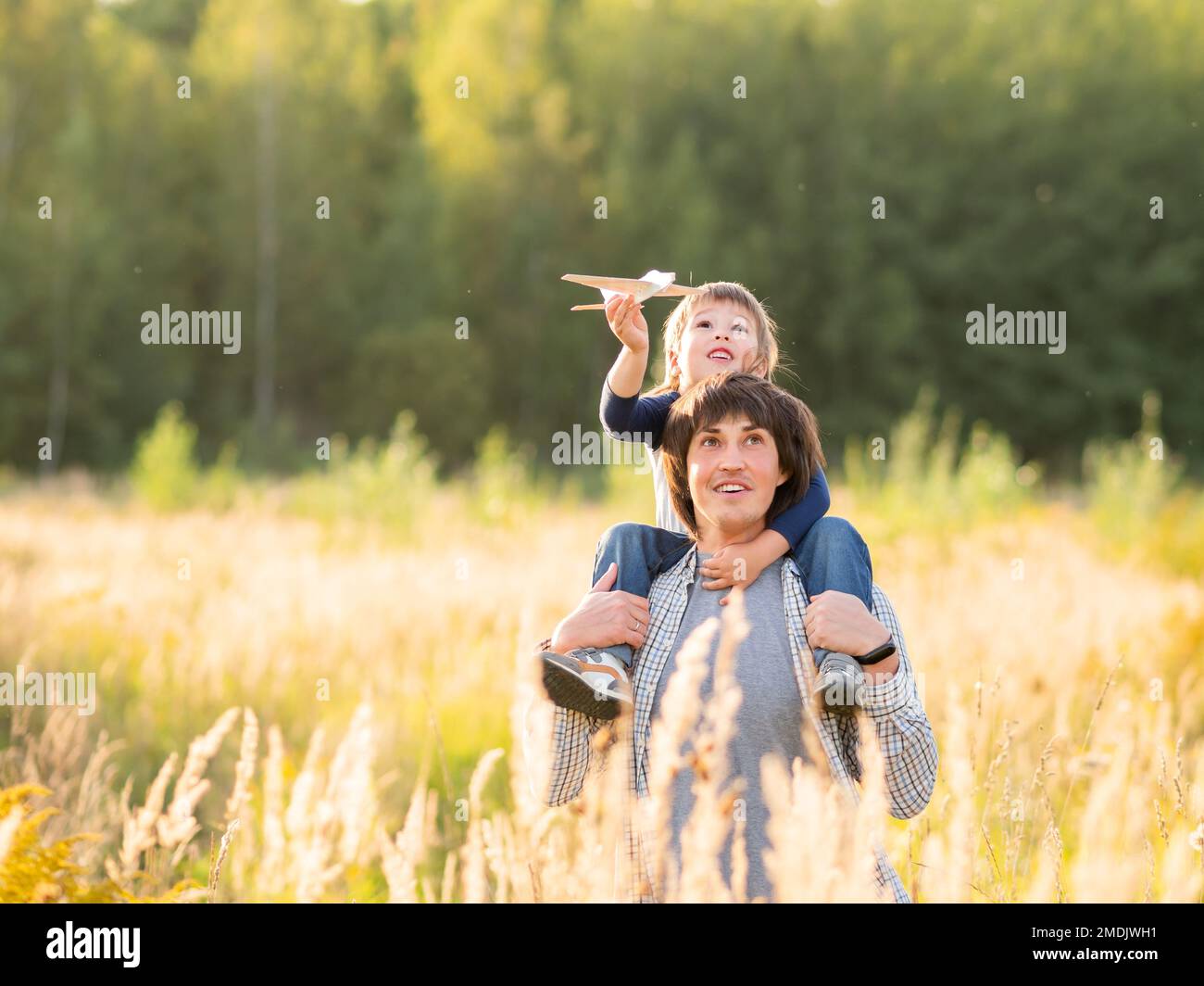 Cute boy and his father play with toy air plane. Happy kid dreams to be ...