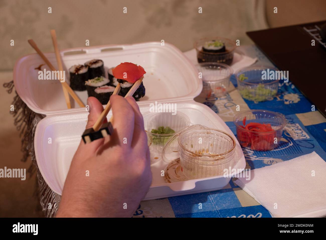 set with sushi from the store in plastic packaging on the table for ...