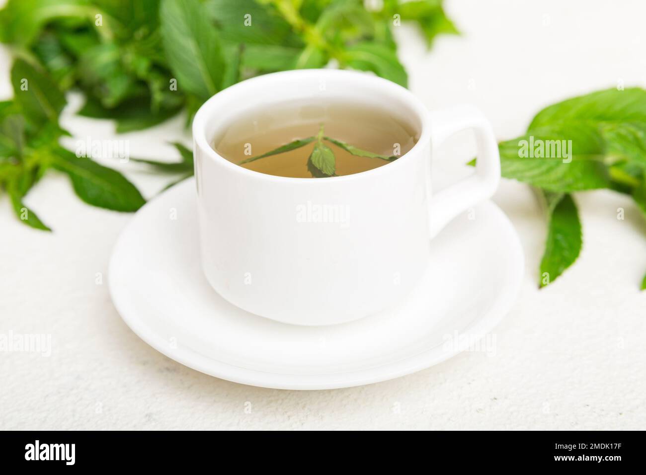Cup of mint tea on table background. Green tea with fresh mint top view ...
