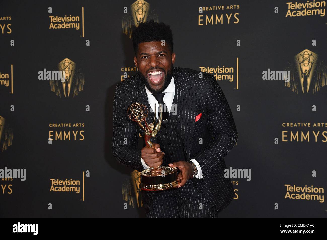 Emmanuel Acho poses with the award for short form nonfiction or reality ...
