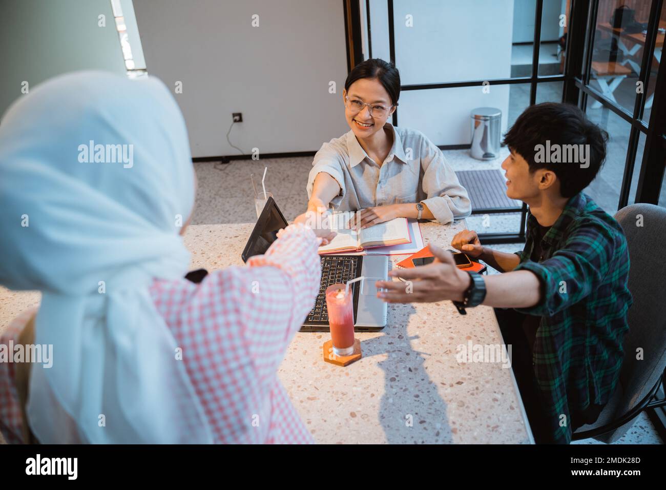 Female student shaking hands with a girl when introduced Stock Photo ...