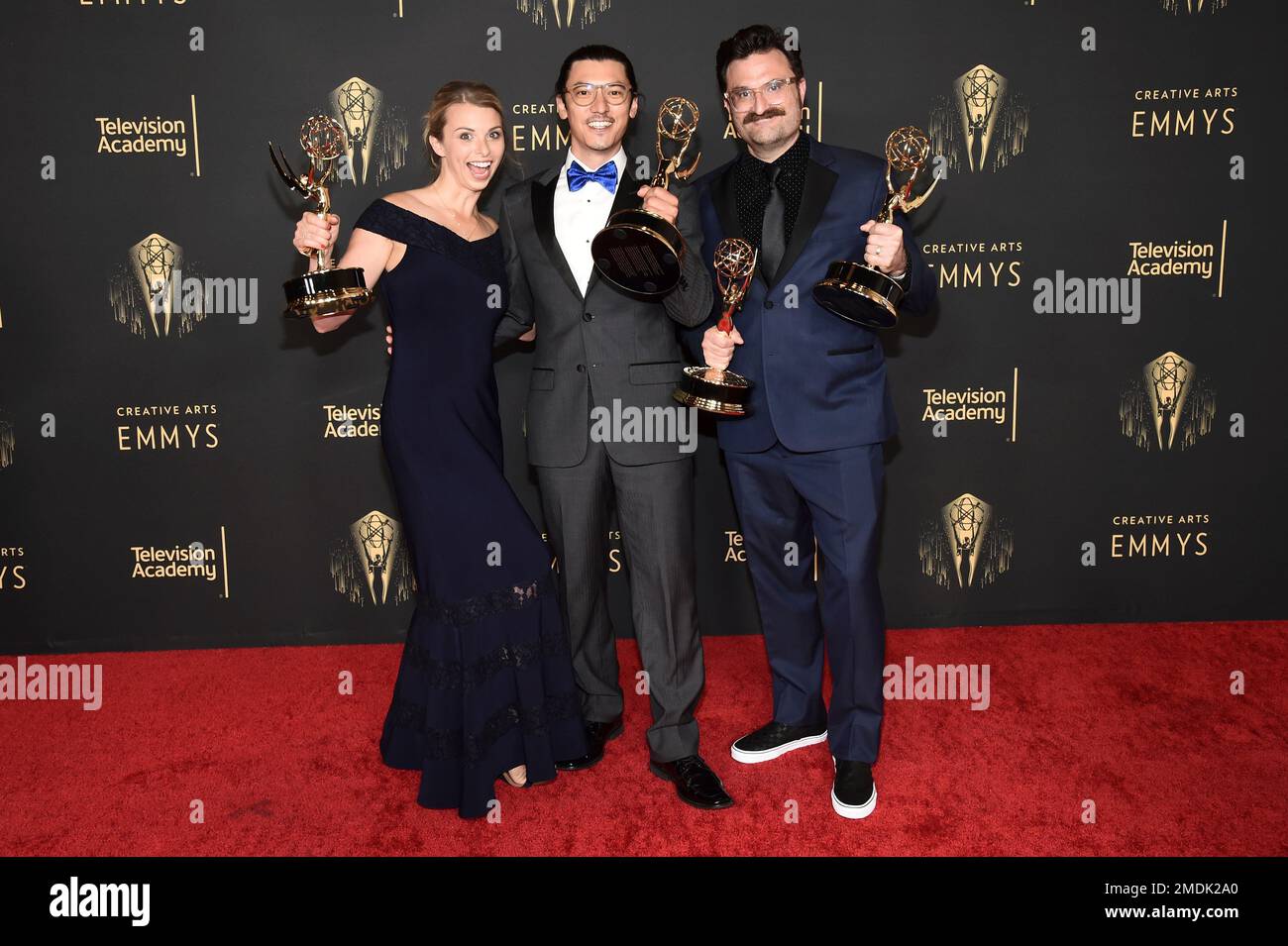 Vickie Curtis, from left, Jeff Orlowski and Davis Coombe, accept the ...