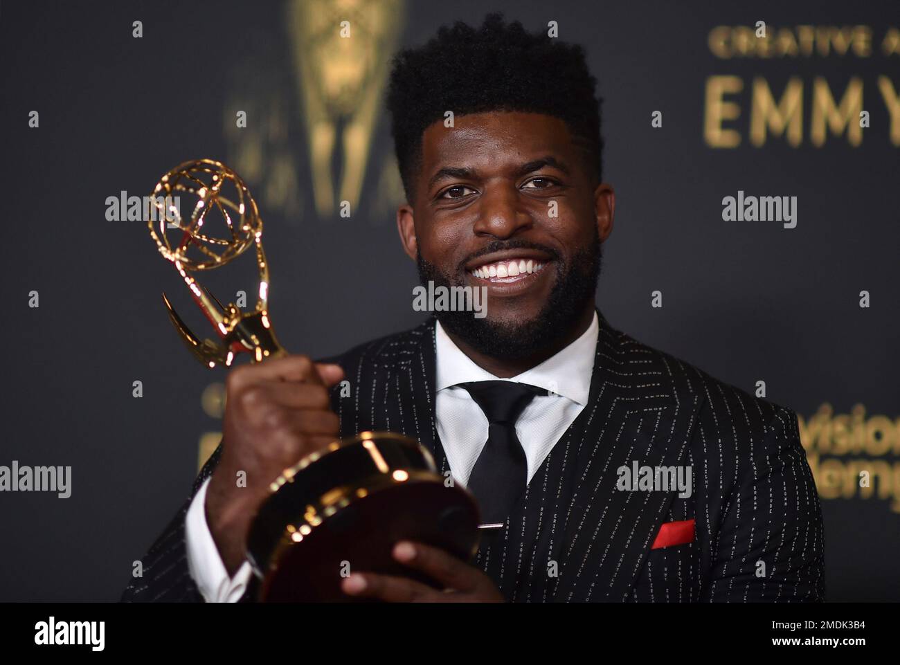 Emmanuel Acho poses with the award for short form nonfiction or reality ...