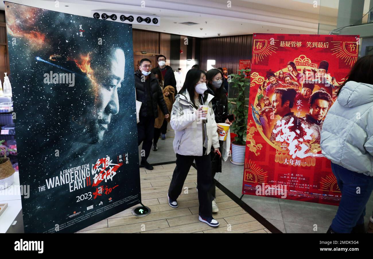 SHANGHAI, CHINA - JANUARY 22, 2023 - People walk past movie posters at ...