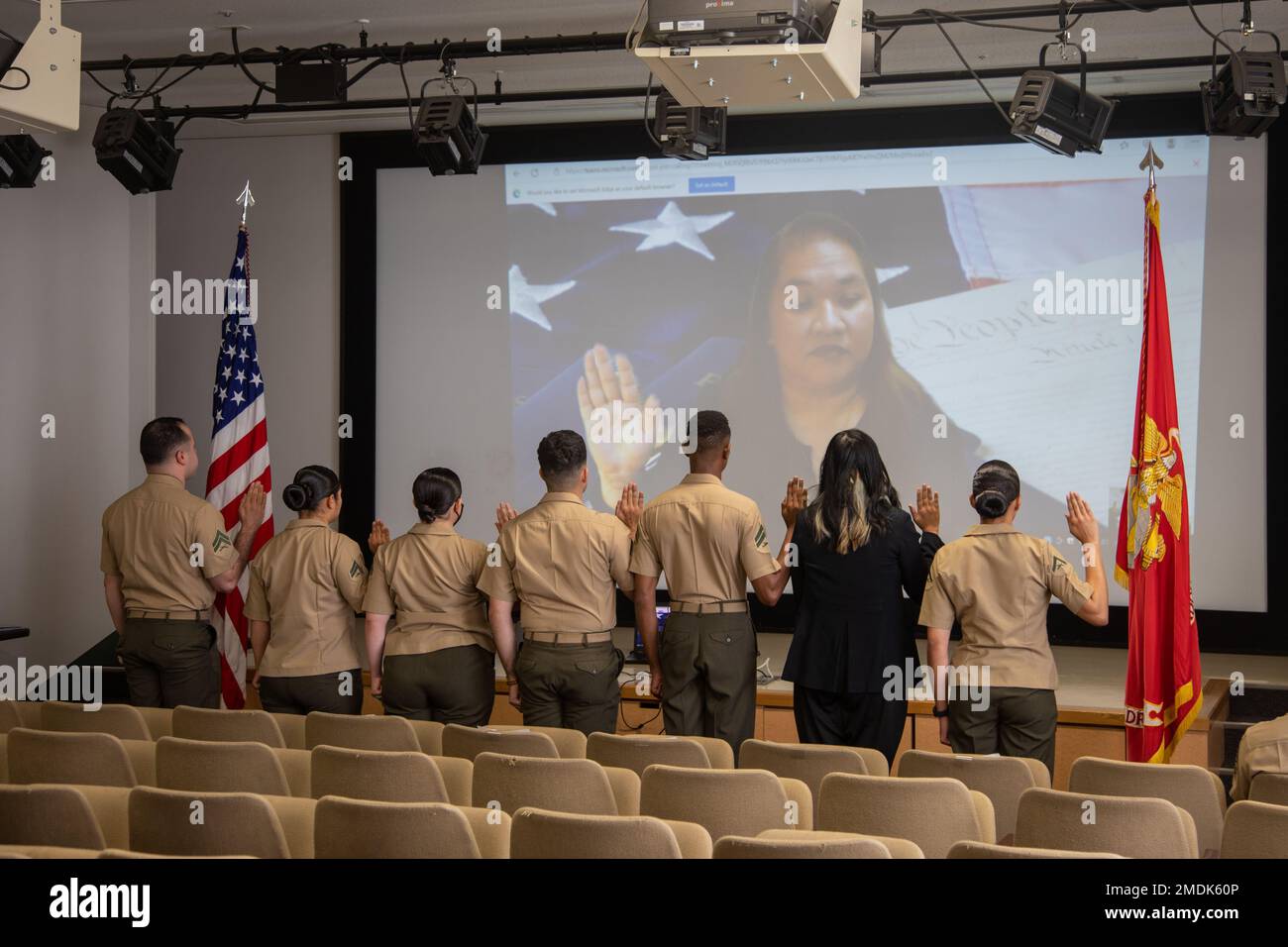 U.S. service members and civilian personnel stand for the Oath of ...