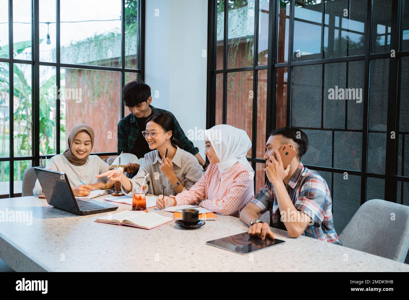 a group of young Asian people doing a task together Stock Photo - Alamy