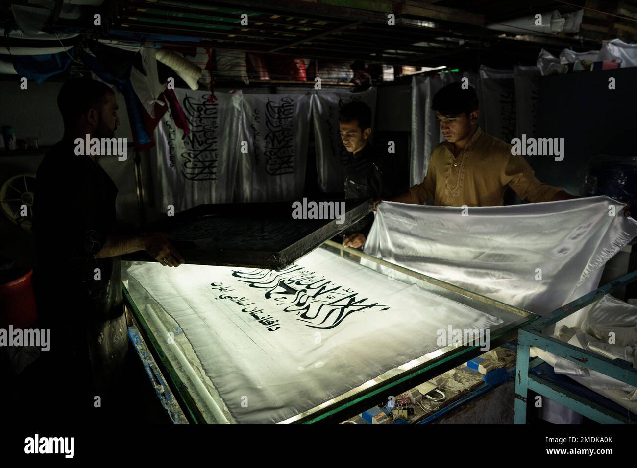 Workers hand print Taliban flags in a small workshop in Kabul's Jawid ...