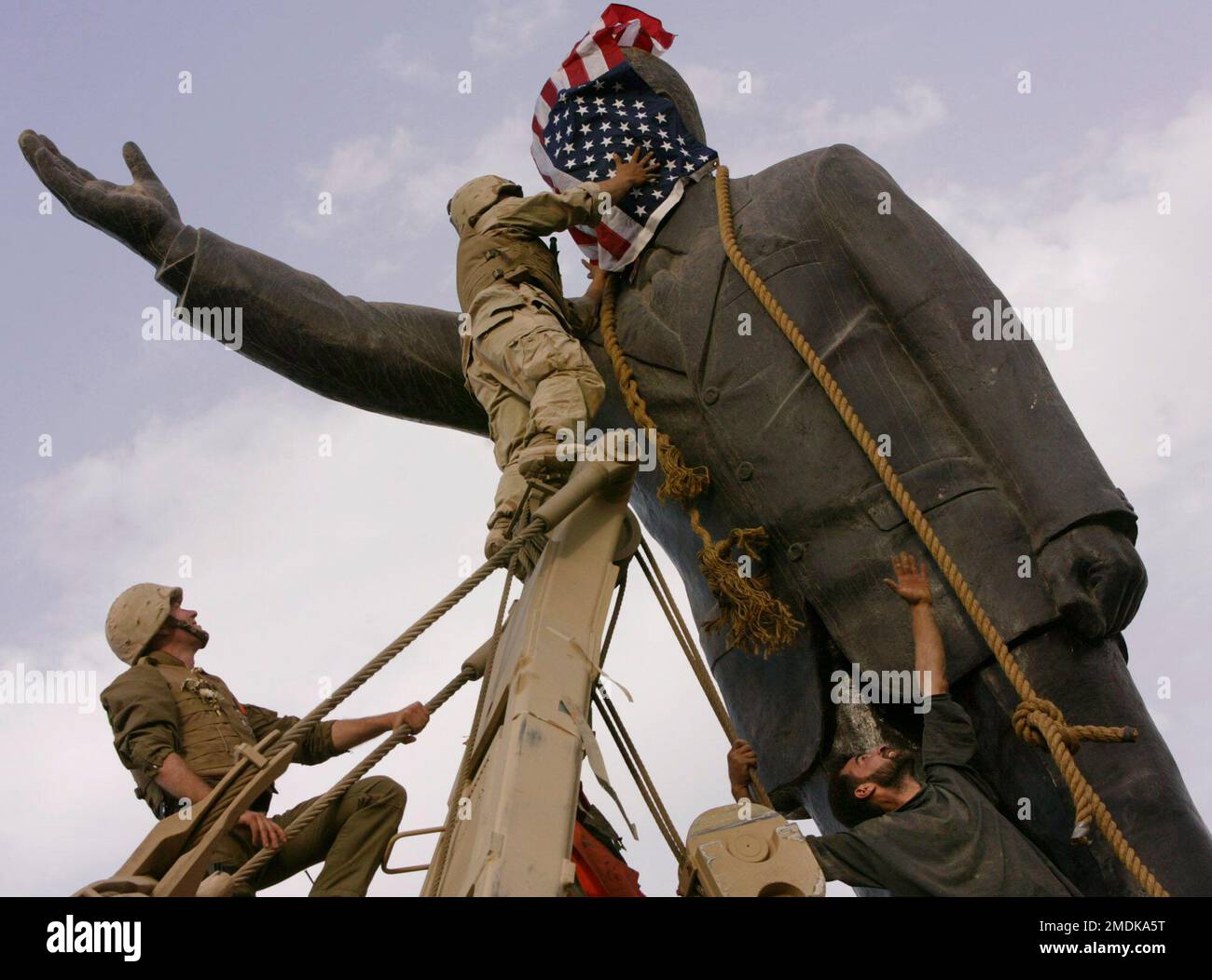 FILE - In this April 9, 2003, file photo, an Iraqi man, bottom right ...