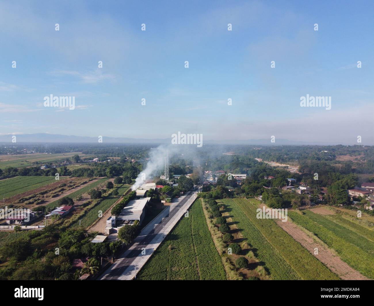 Drone image capture over a smoking field and farm landscape Stock Photo ...