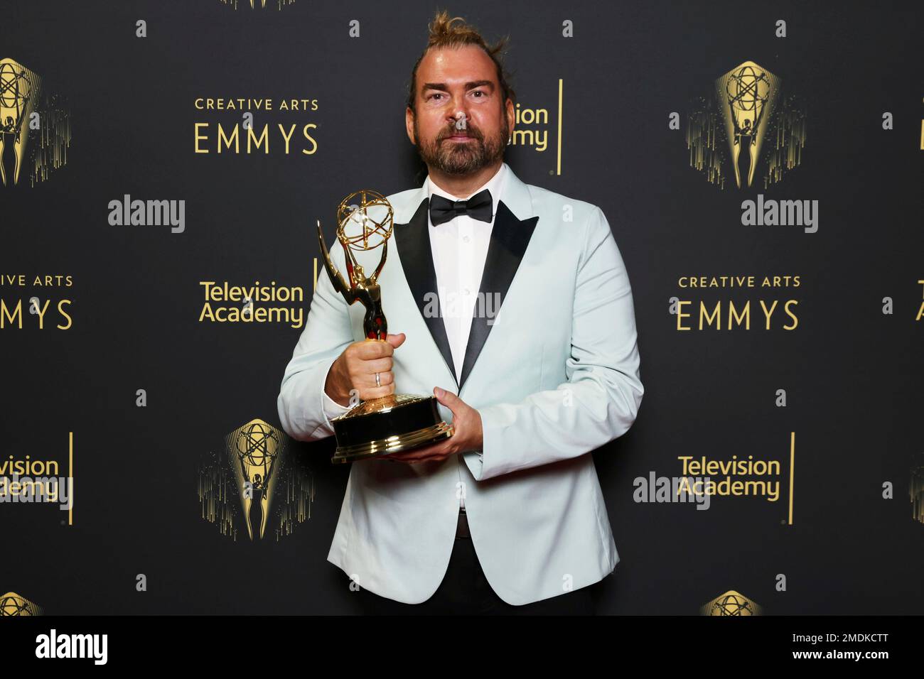 March Pilcher poses for a portrait with his award for outstanding ...