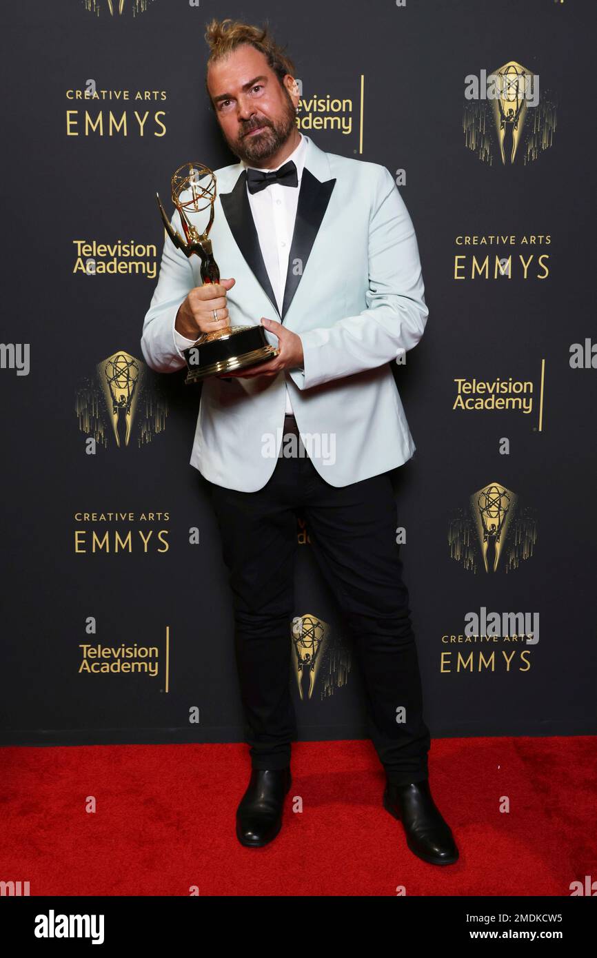 March Pilcher poses for a portrait with his award for outstanding ...