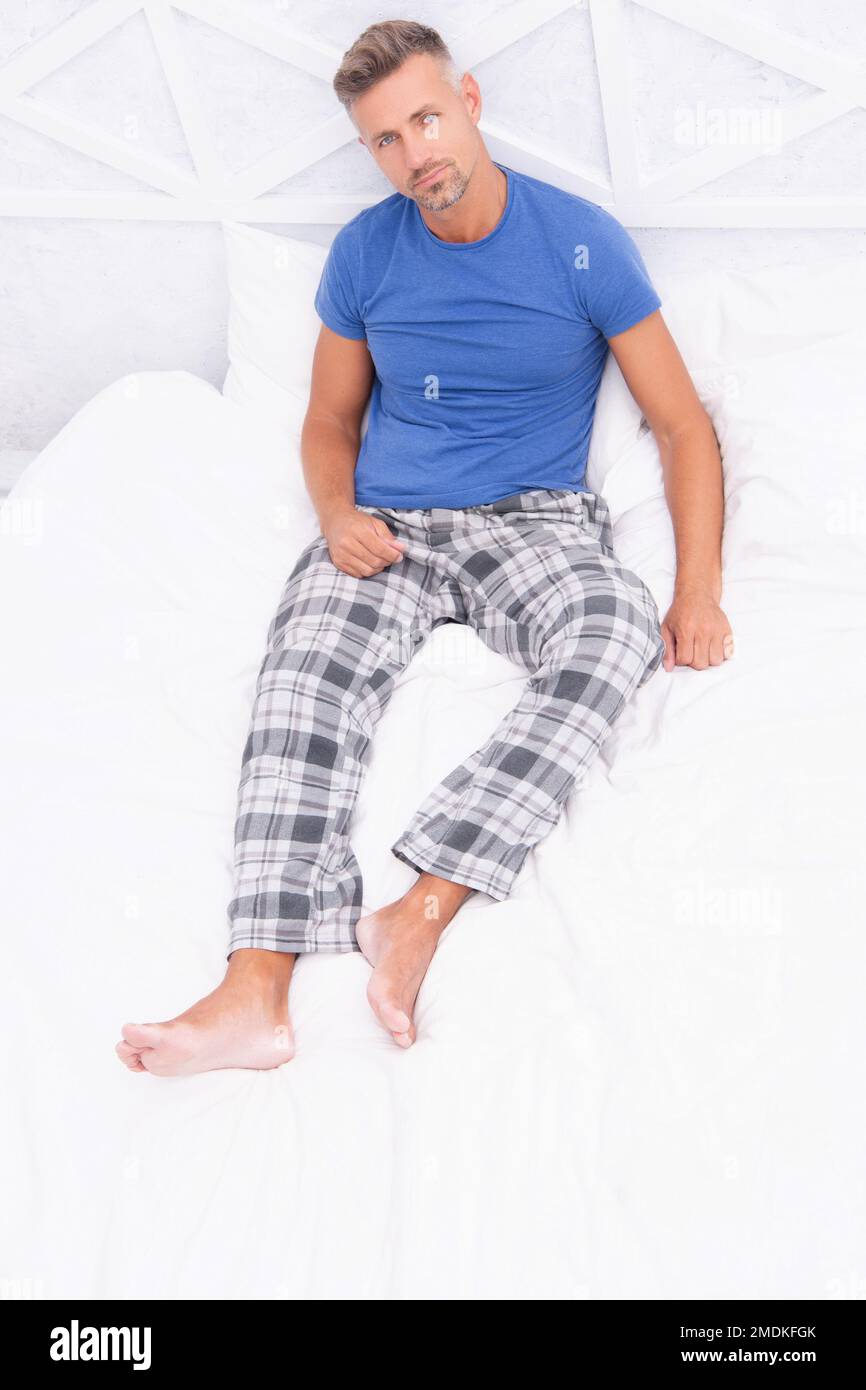 Man enjoying rest in bed. Man resting in bed. Man having rest in ...