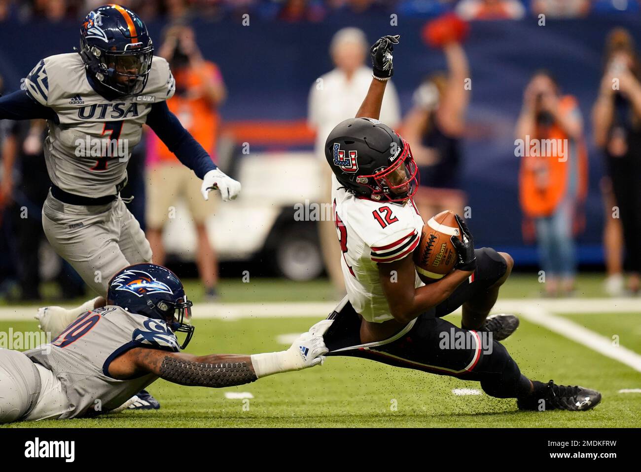Lamar wide receiver Marcellus Johnson (12) is pulled down behind the ...