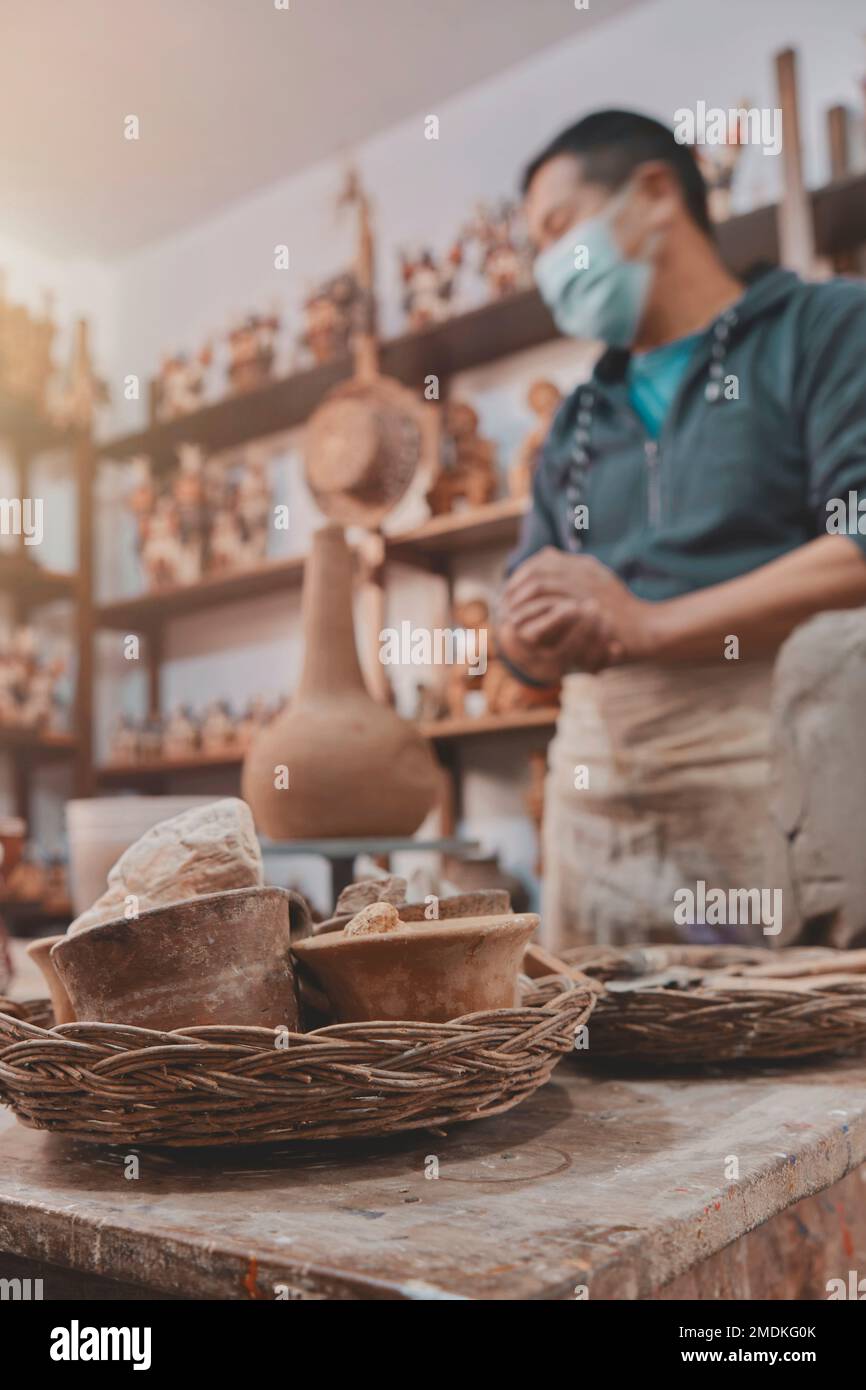 Man molding clay to make ceramics with his hands, Artisan working in ...