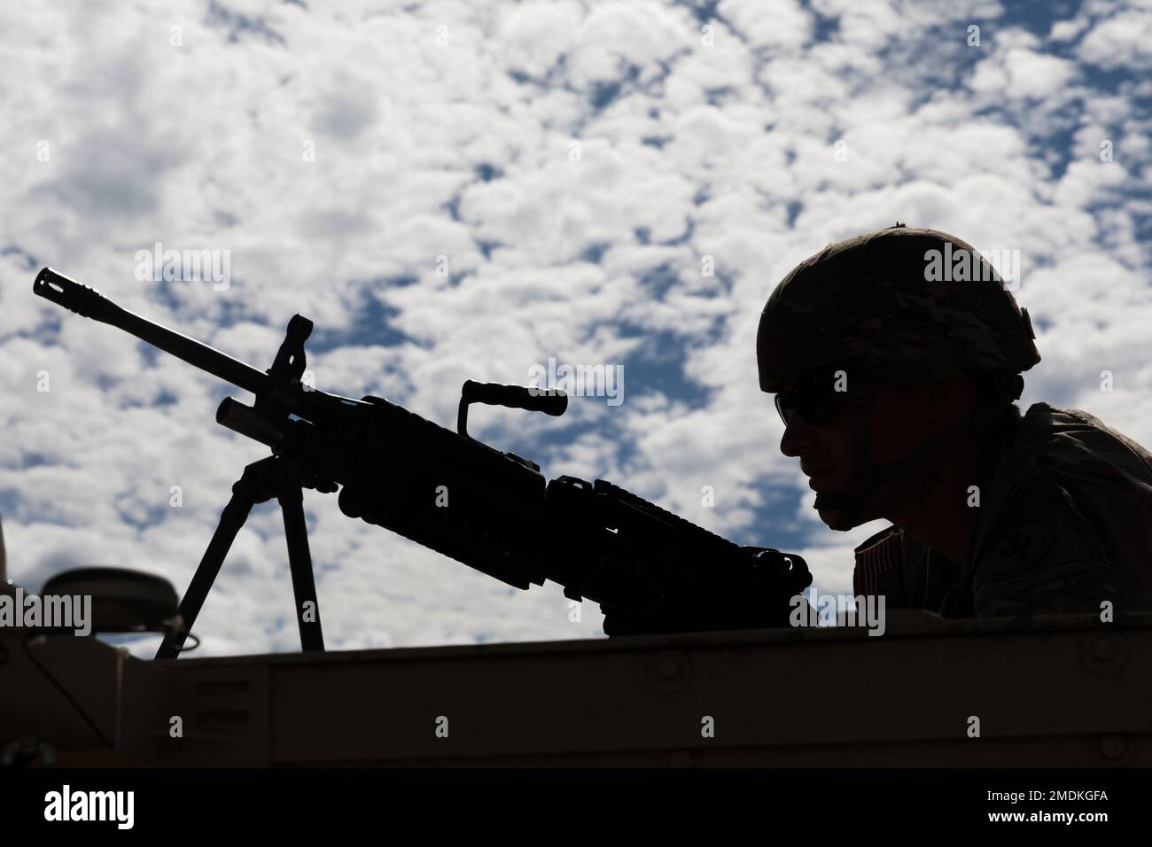 A Soldier from the 940th Movement Control Team scans for opposing ...