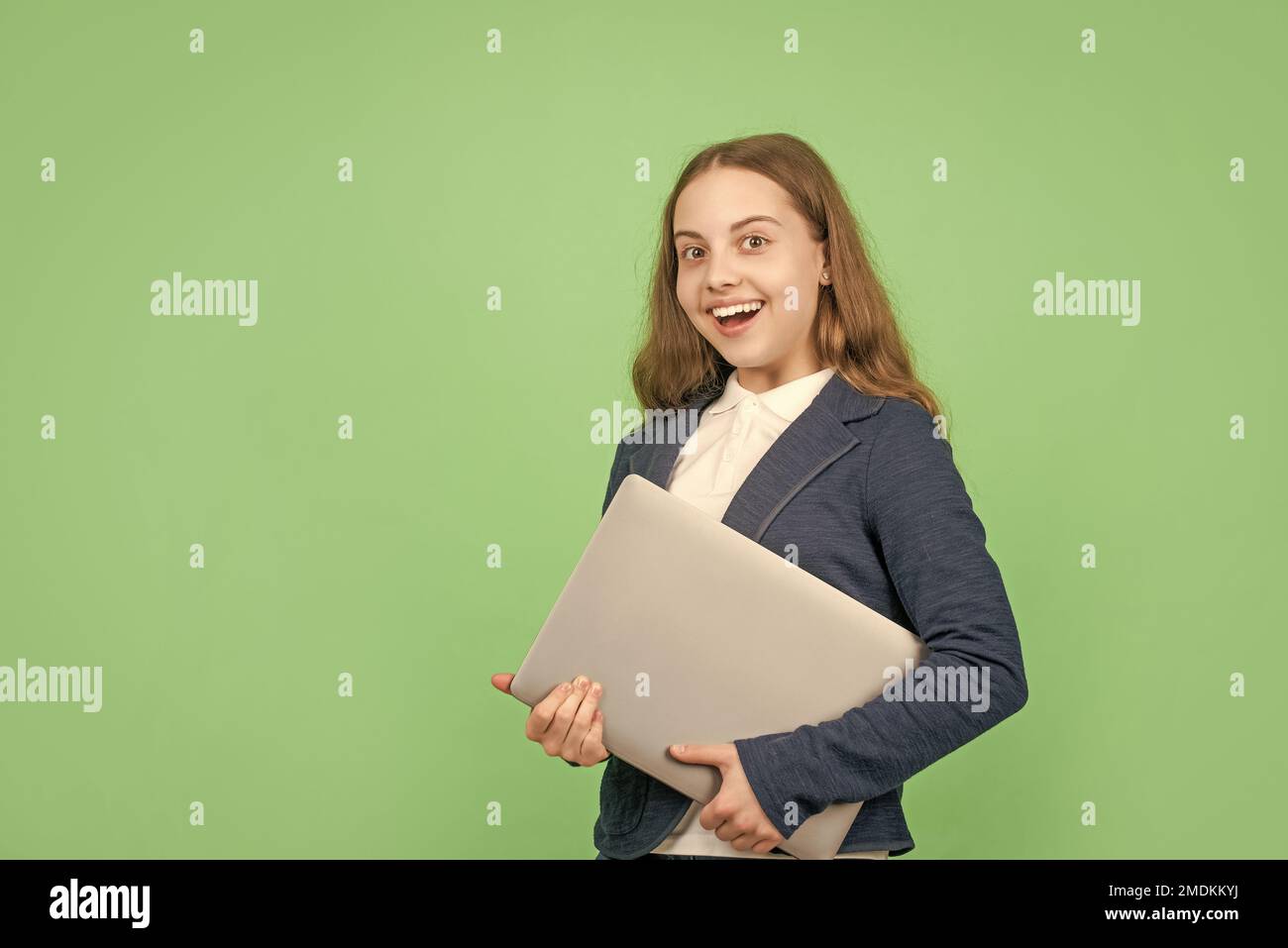 happy child with laptop on green background Stock Photo - Alamy