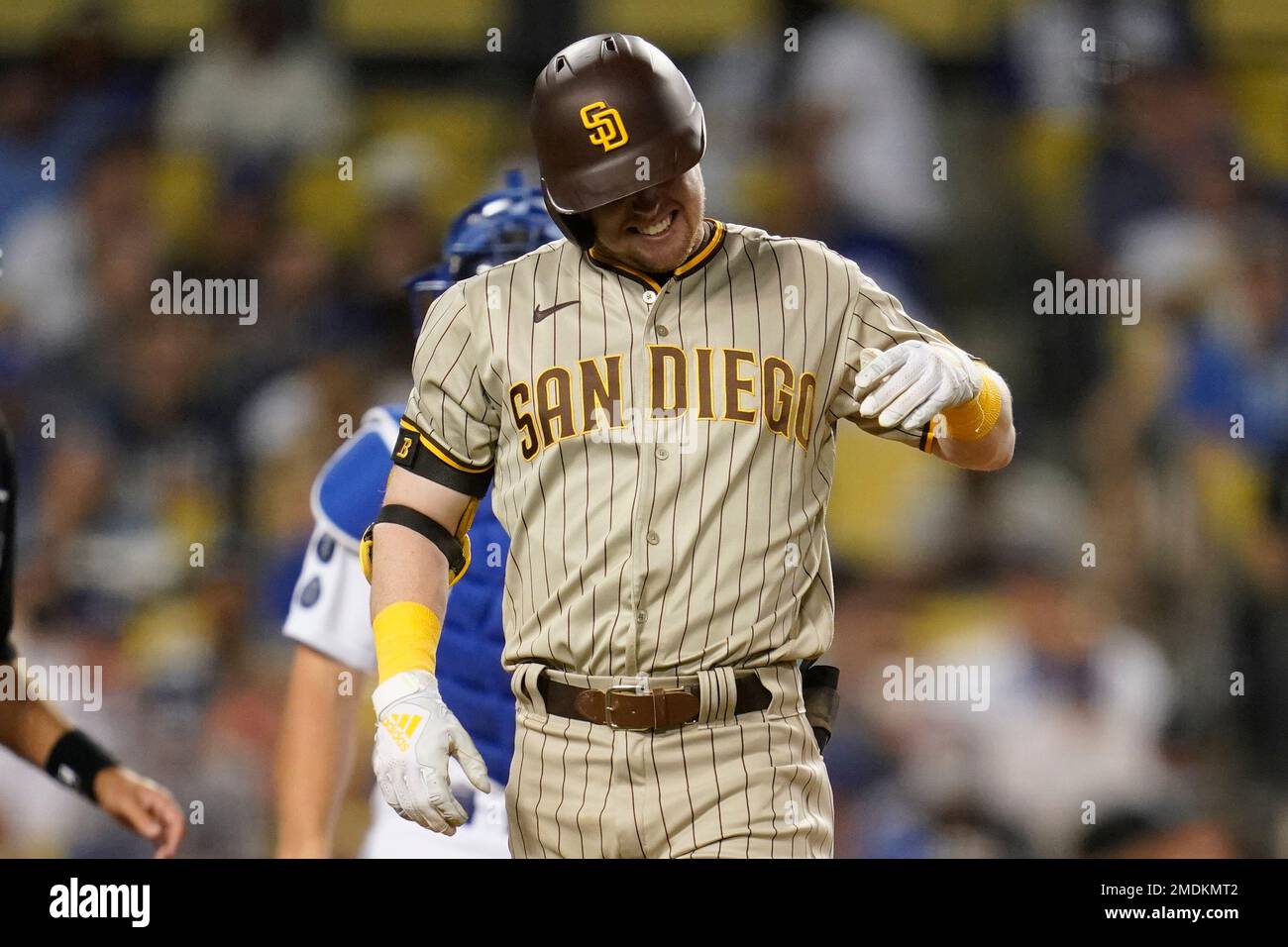 San Diego Padres' Jake Cronenworth (9) reacts after getting hit by a ...