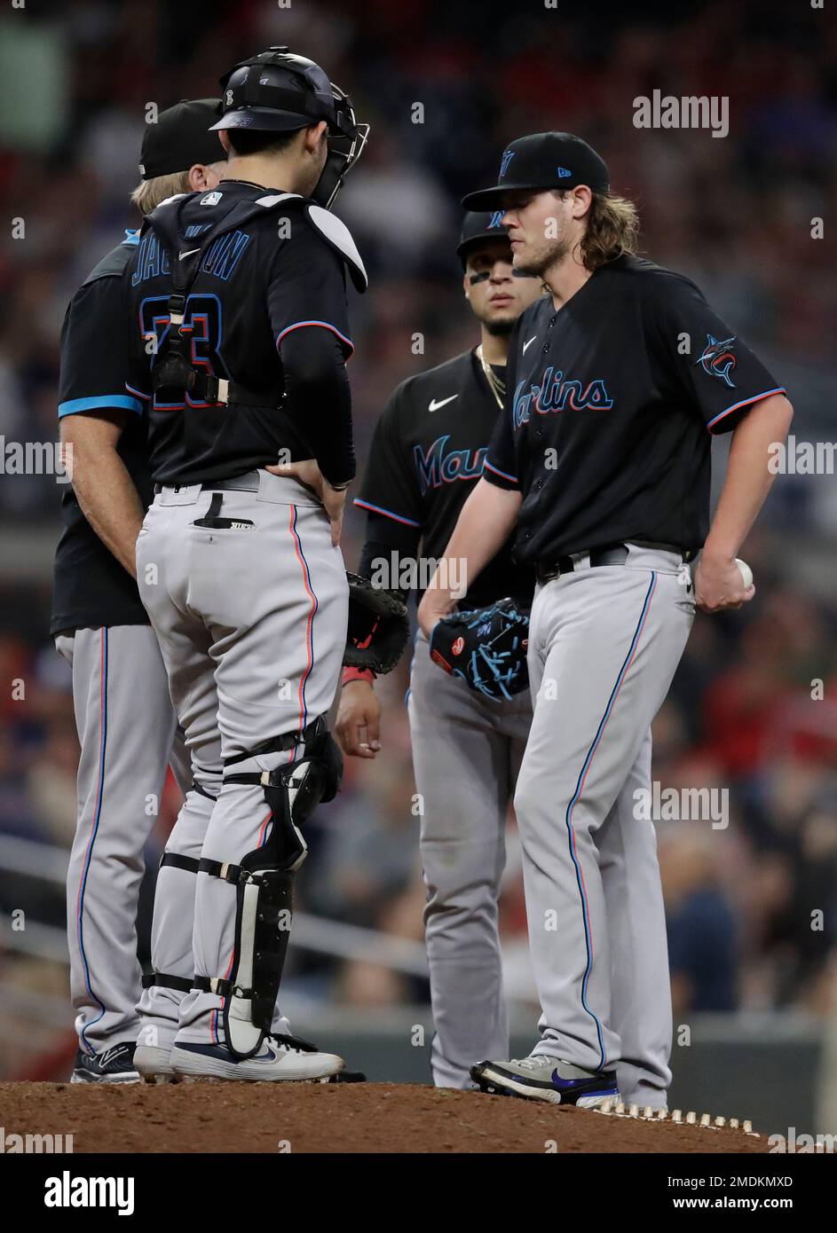 Miami Marlins' Steven Okert, right, meets on the mound with catcher ...