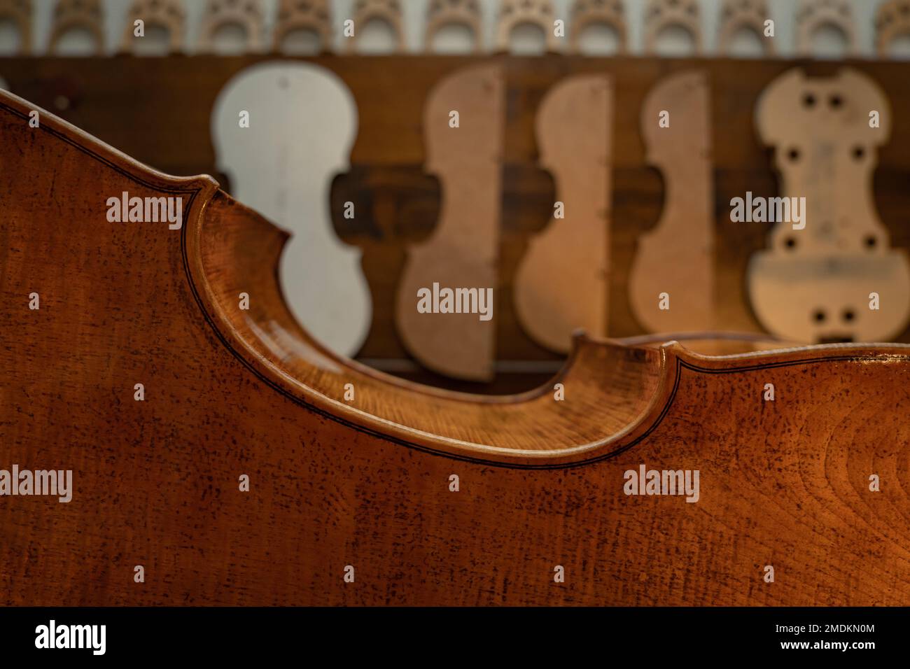 A shallow focus of a violin with its making parts hang on the wall on ...